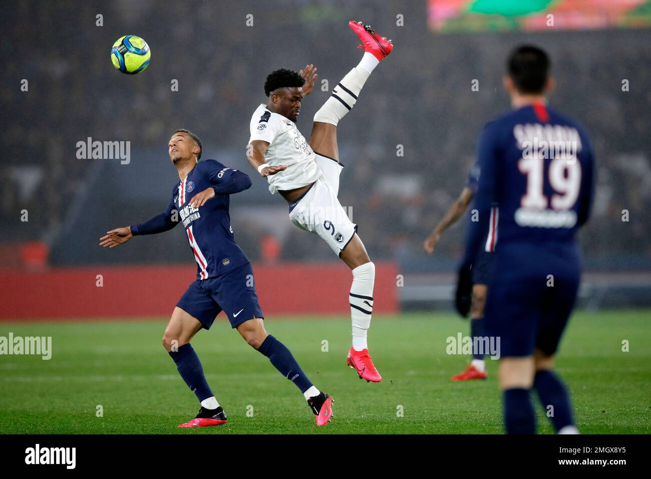 PSG's Thilo Kehrer, left, and Bordeaux's Josh Maja vie for the ball ...