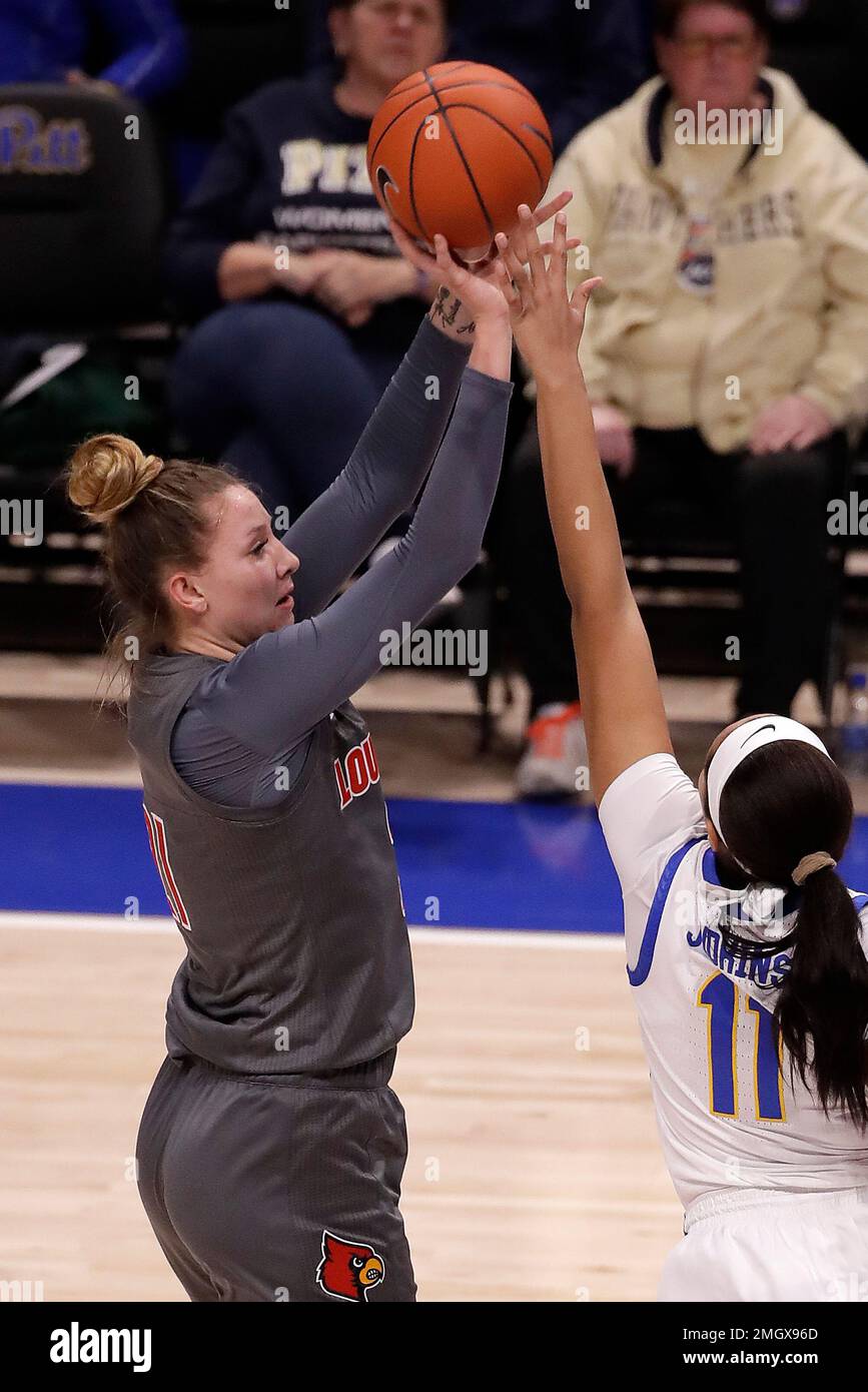Louisville's Kylee Shook, left, gets off a three-point shot over ...
