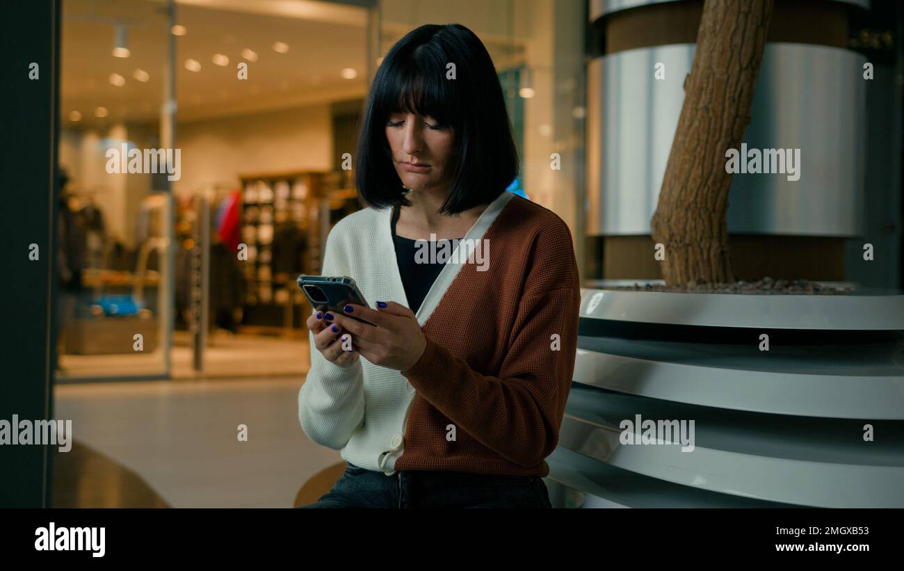 Indoors girl lady female with phone annoyed sad upset stressed woman ...