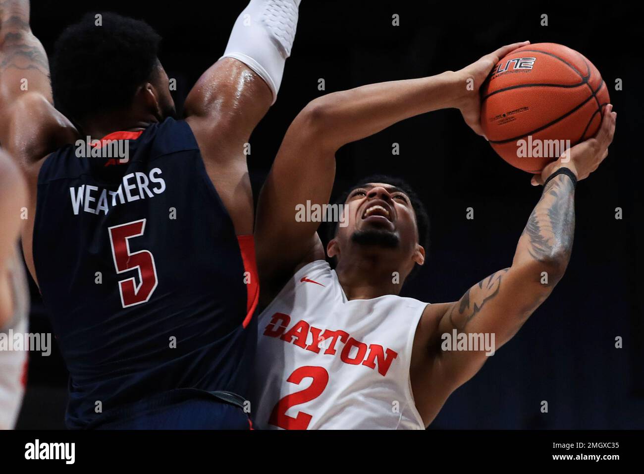 Duquesne's Marcus Weathers (5) defends Dayton's Ibi Watson (2) in the ...