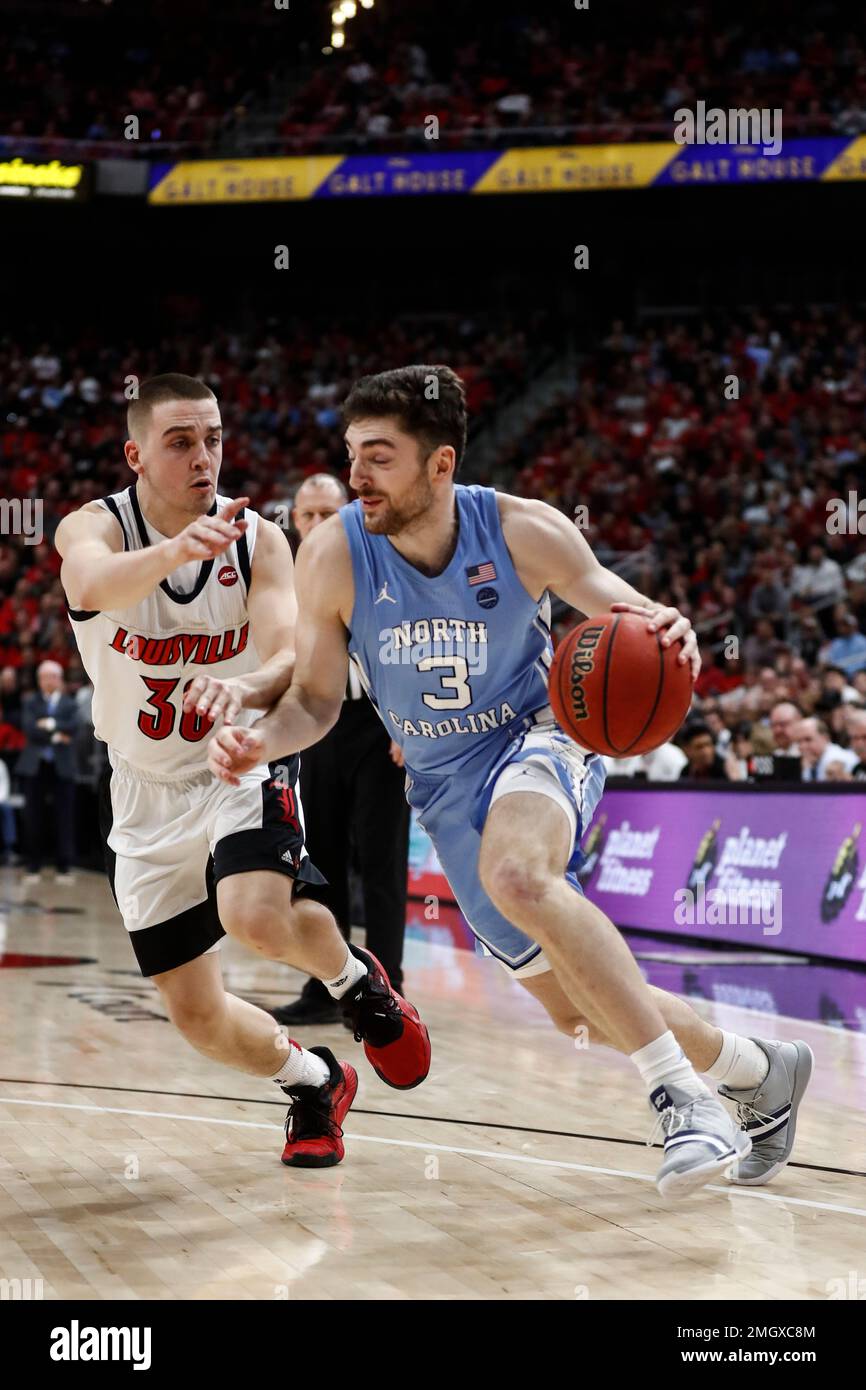 North Carolina guard Andrew Platek (3) drives past Louisville guard ...