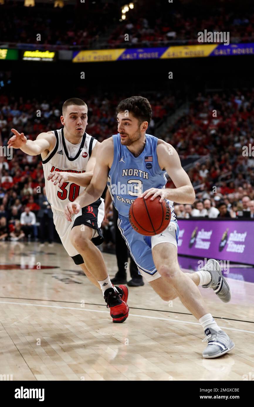 North Carolina guard Andrew Platek (3) drives past Louisville guard ...