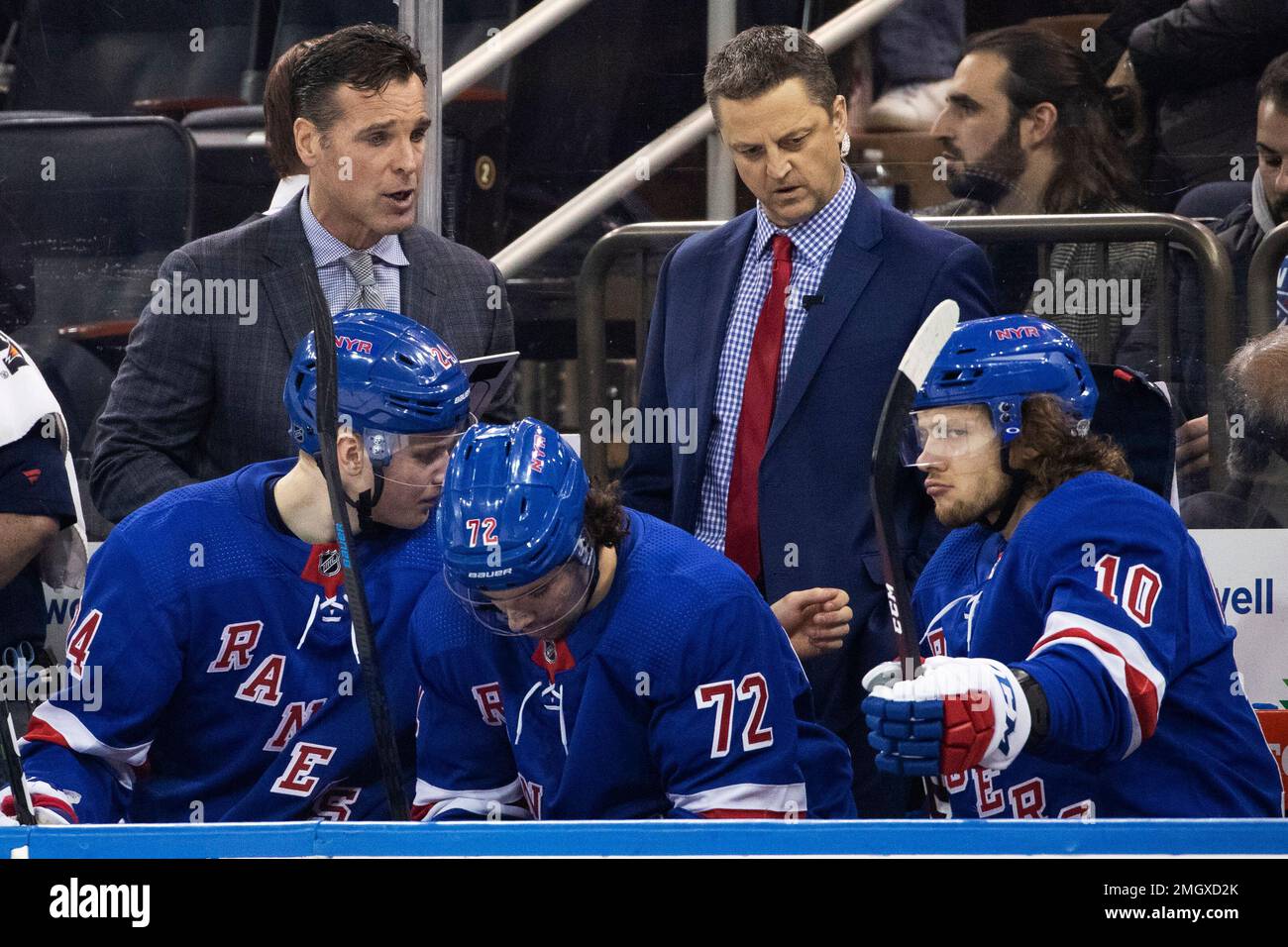 New York Rangers coach David Quinn, left, talks to his players during ...