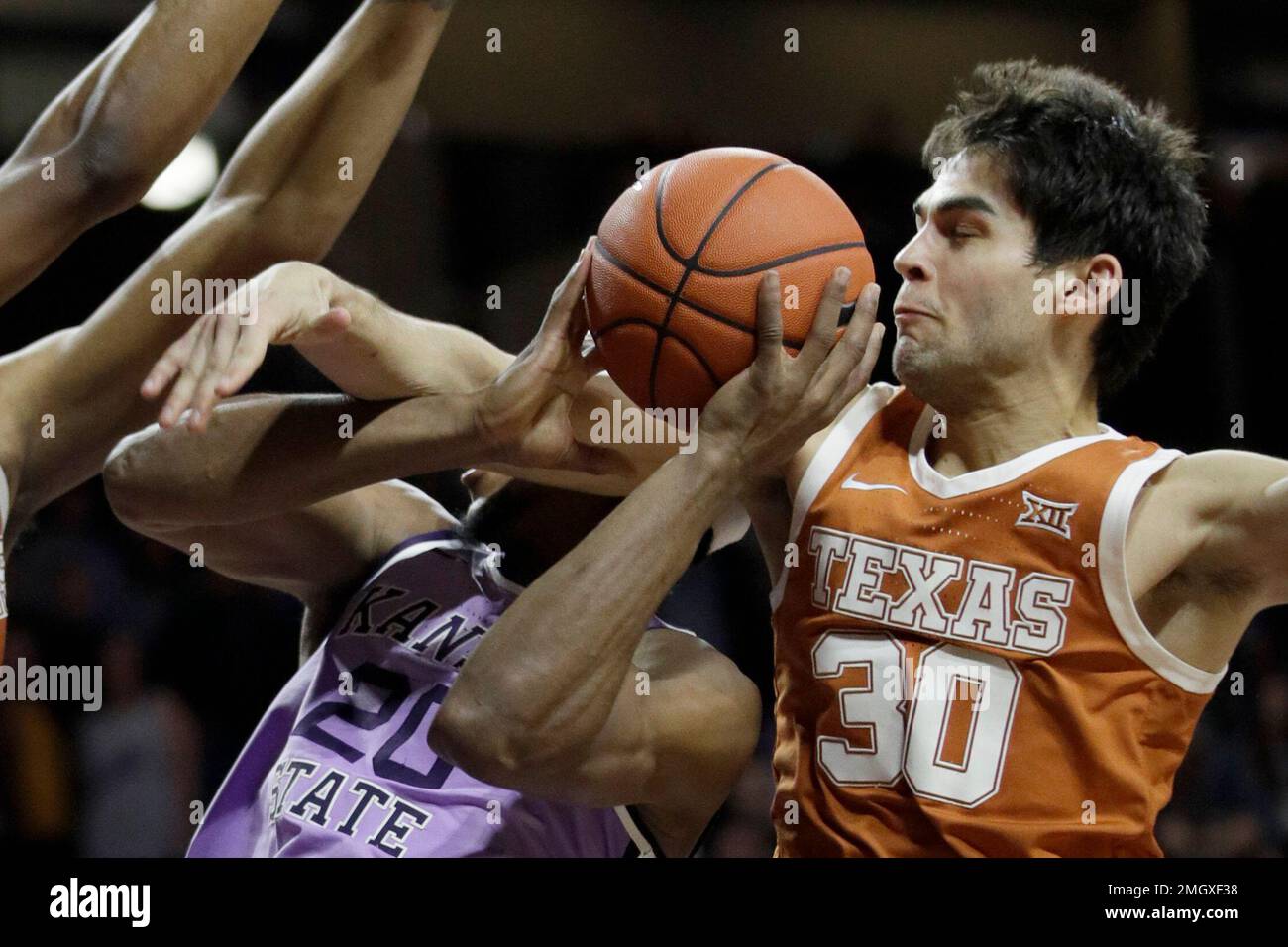Kansas State forward Xavier Sneed (20) is fouled by Texas forward Brock ...