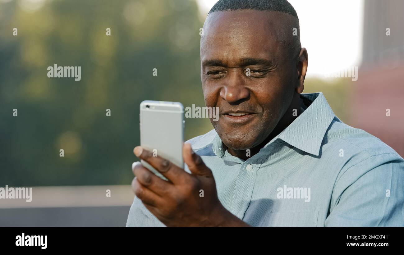 Close up senior African American man speaking video call chat looking ...
