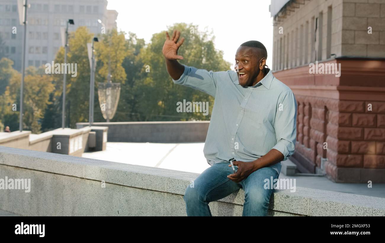 Welcoming middle aged businessman waving hi-res stock photography and ...