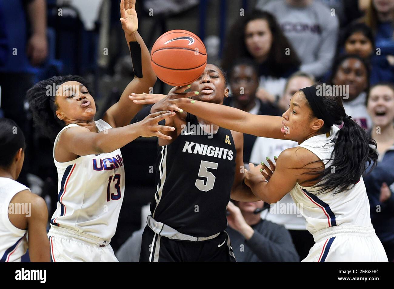 Connecticut's Christyn Williams (13) and Megan Walker (3) defend ...