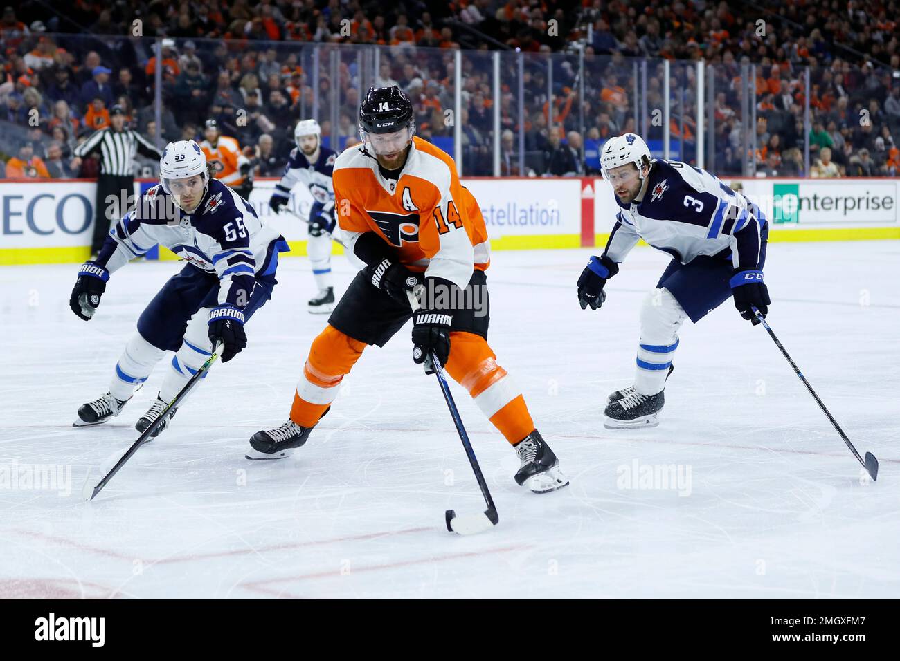 Philadelphia Flyers' Sean Couturier (14) tries to skate past Winnipeg ...