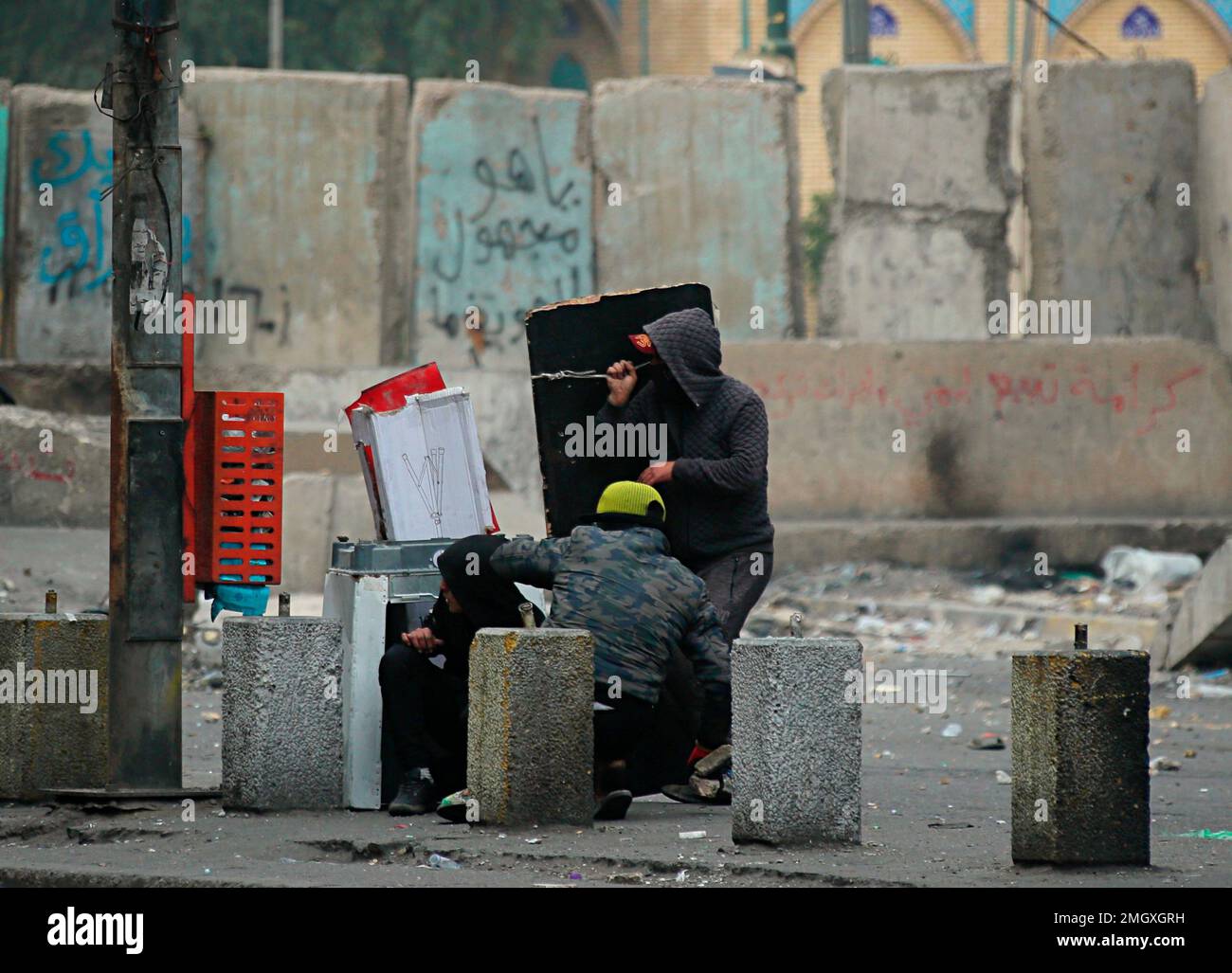 Anti-government protesters take cover while security force use ...