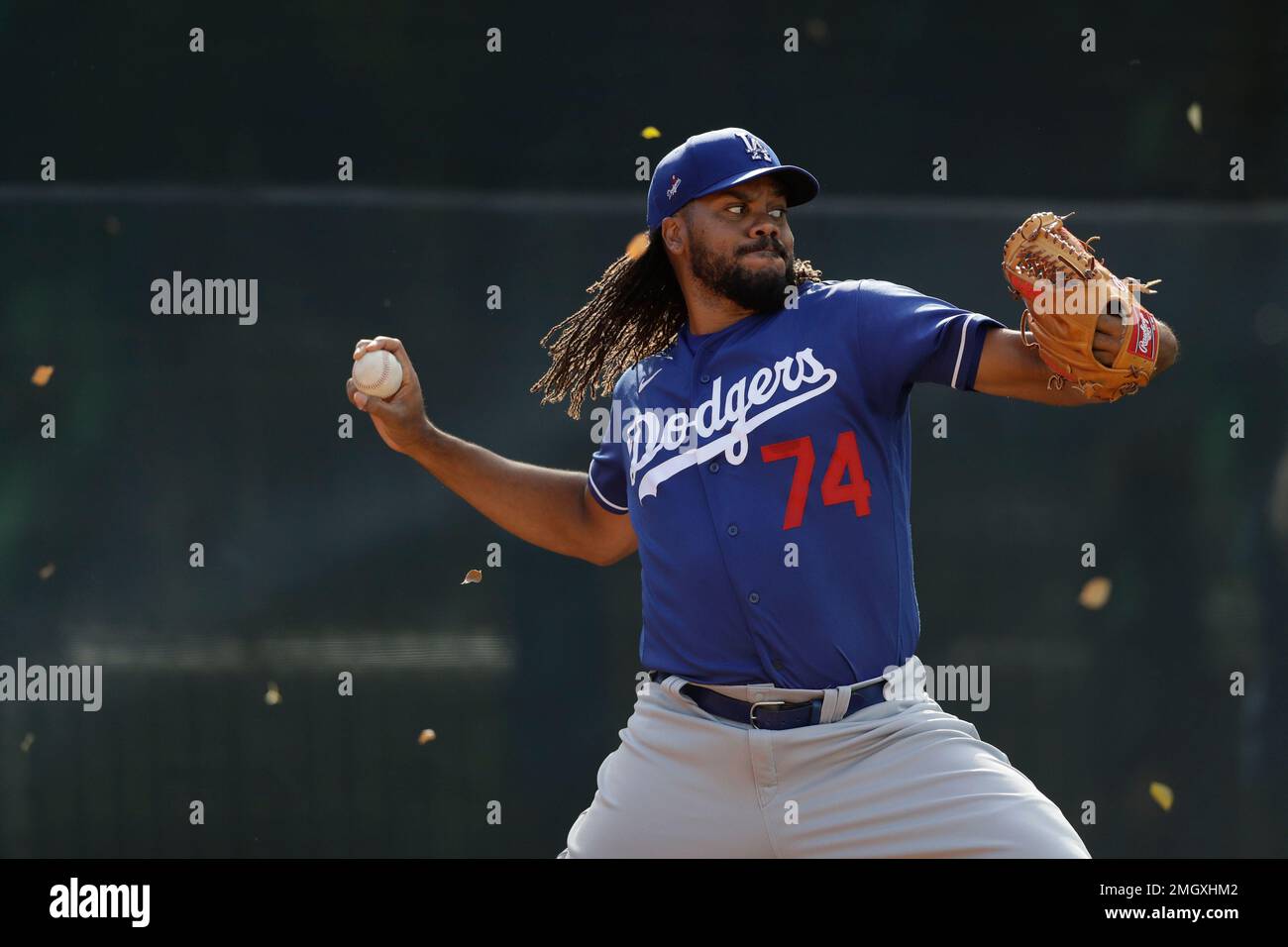 Los Angeles Dodgers relief pitcher Kenley Jansen throws as a gust of ...