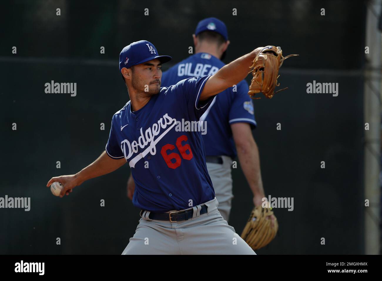 Los Angeles Dodgers pitcher Mitchell White, left, throws alongside ...