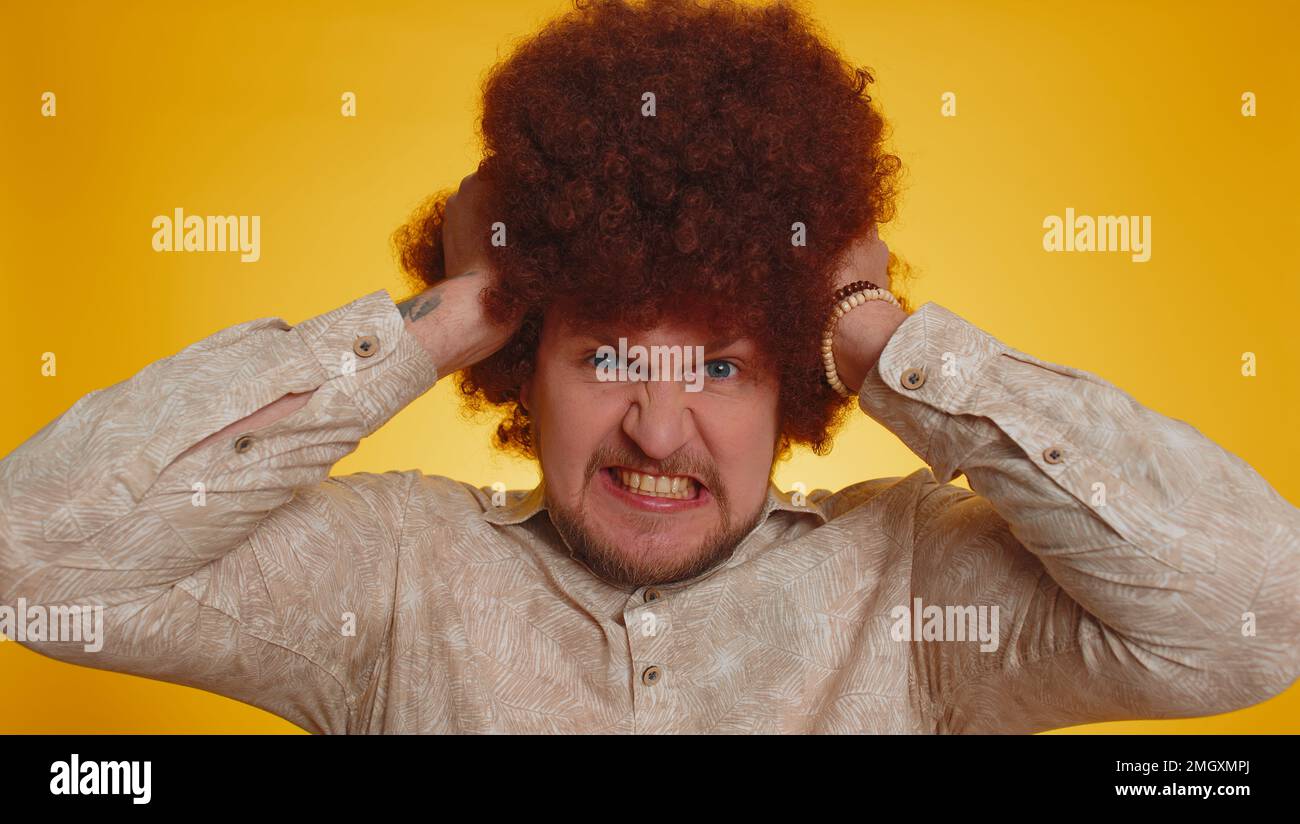 Angry man with lush Afro hairstyle coiffure screams from stress tension ...