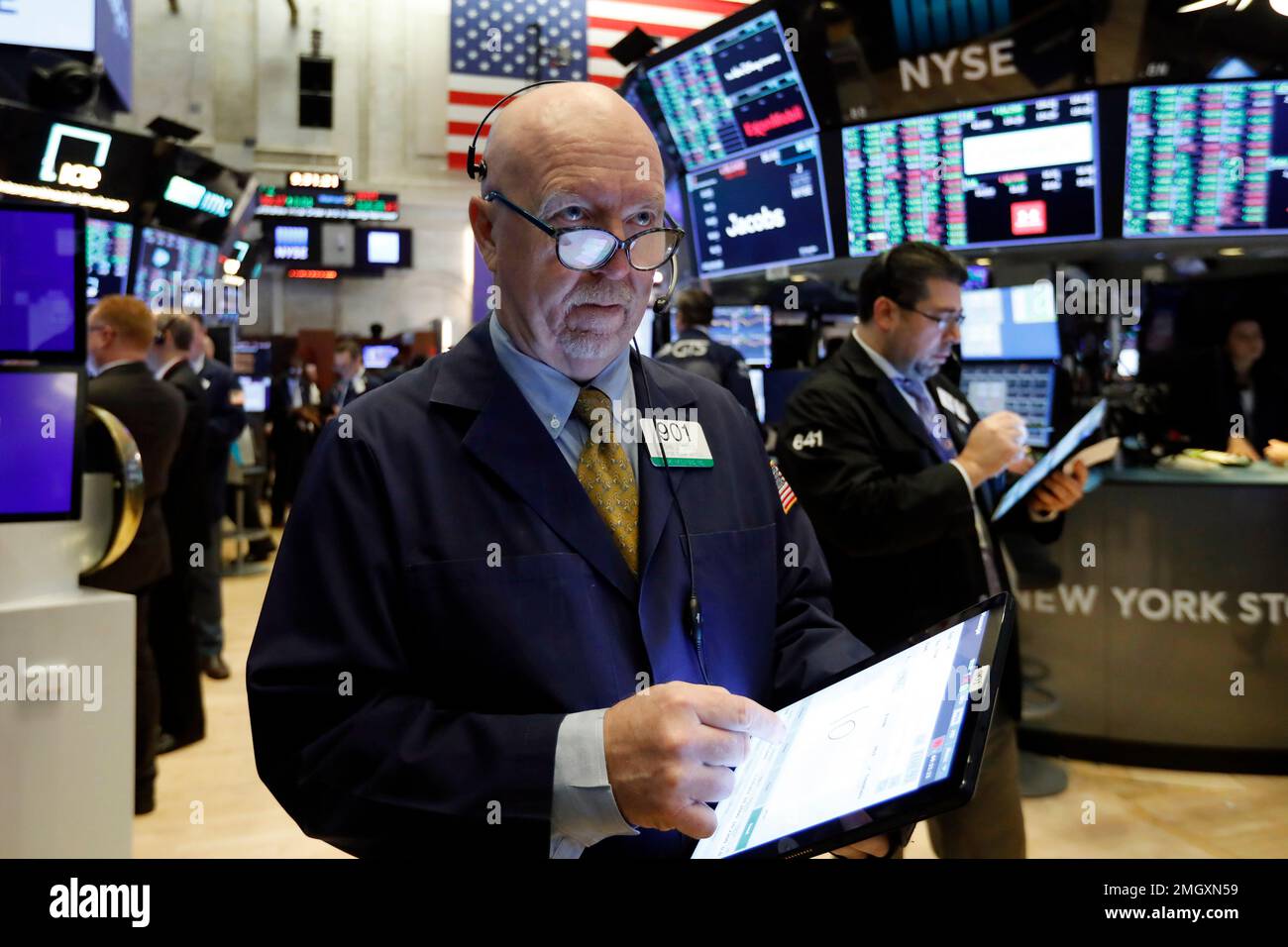 FILE - In this Feb. 6, 2020, file photo trader John Doyle works on the ...