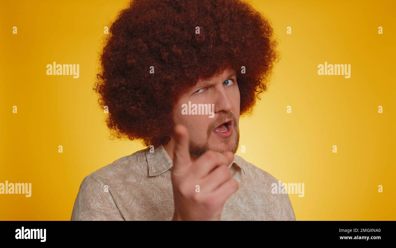 Bearded man with lush afro hairstyle coiffure shakes finger and saying ...