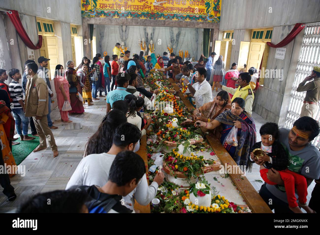 Indian Hindu devotees offer prayer at a row of Shivlings, idols ...