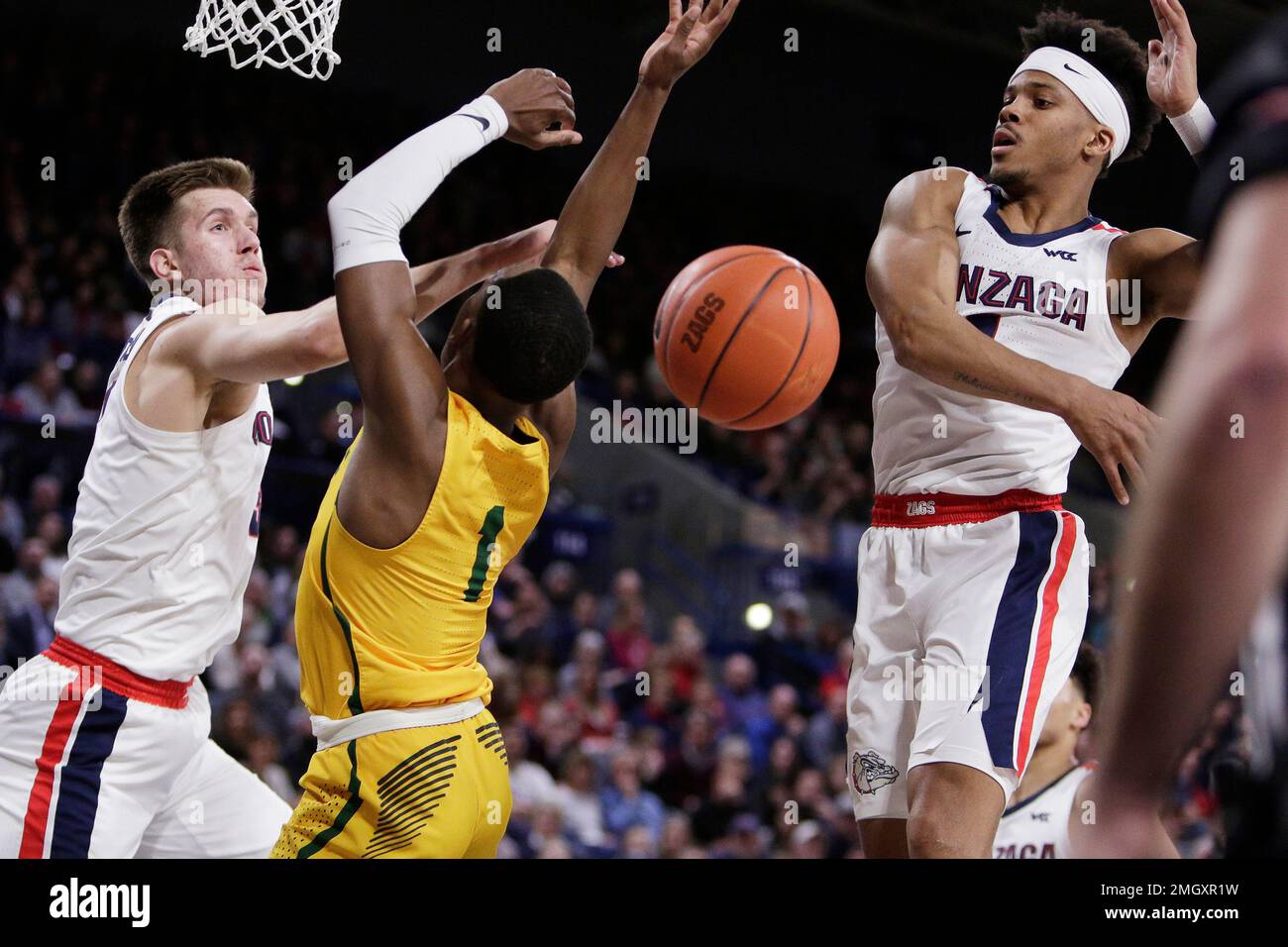 San Francisco guard Jamaree Bouyea, center, has his shot blocked by Gonzaga guard Admon Gilder ...