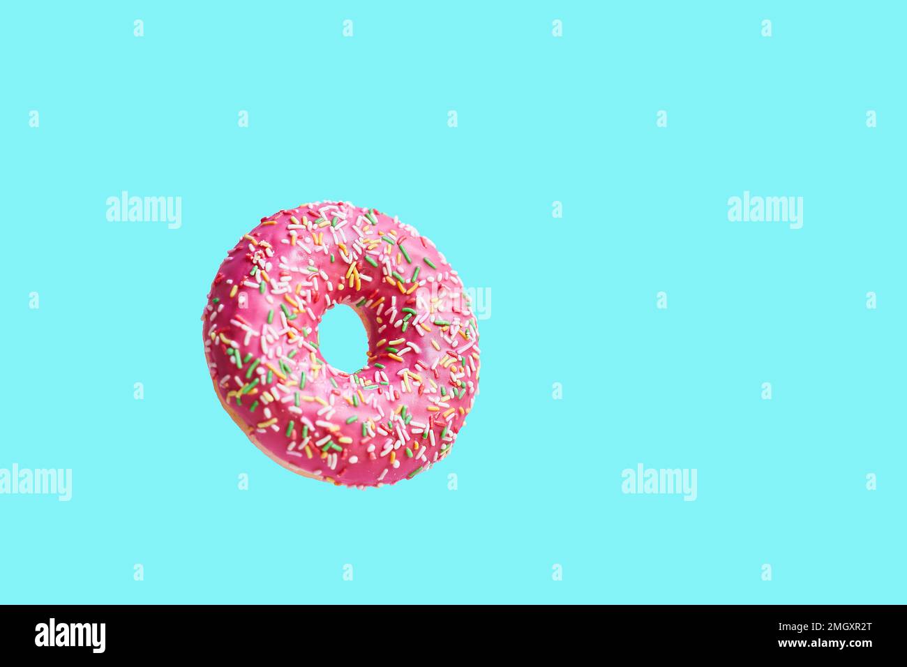 Pink donut on a blue background. Space for text Stock Photo - Alamy
