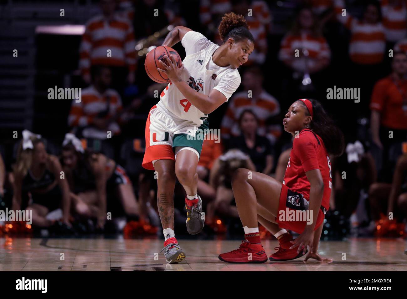 Miami guard Endia Banks (4) looks for an opening past North Carolina ...