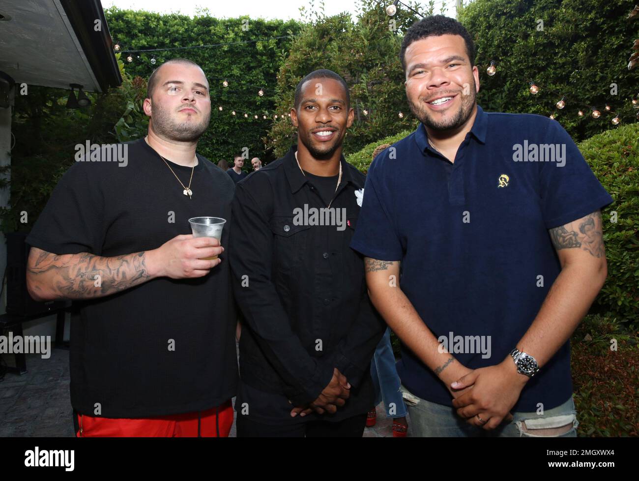 Victor Cruz, center, and guest seen at Levi's x Victor Cruz Foundation ...