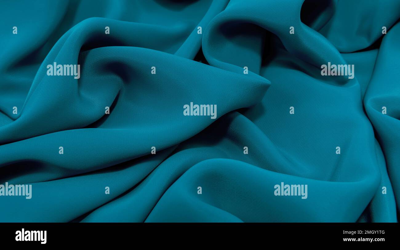 The texture of a smooth elegant fabric of silk, satin blue with folds ...