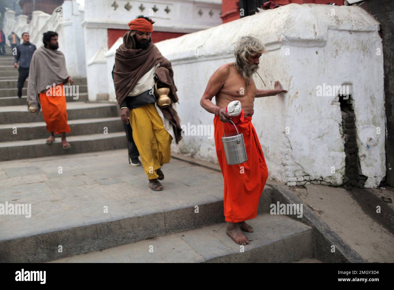 Hindu holy men arrive to take a bath in the Bagmati river near ...