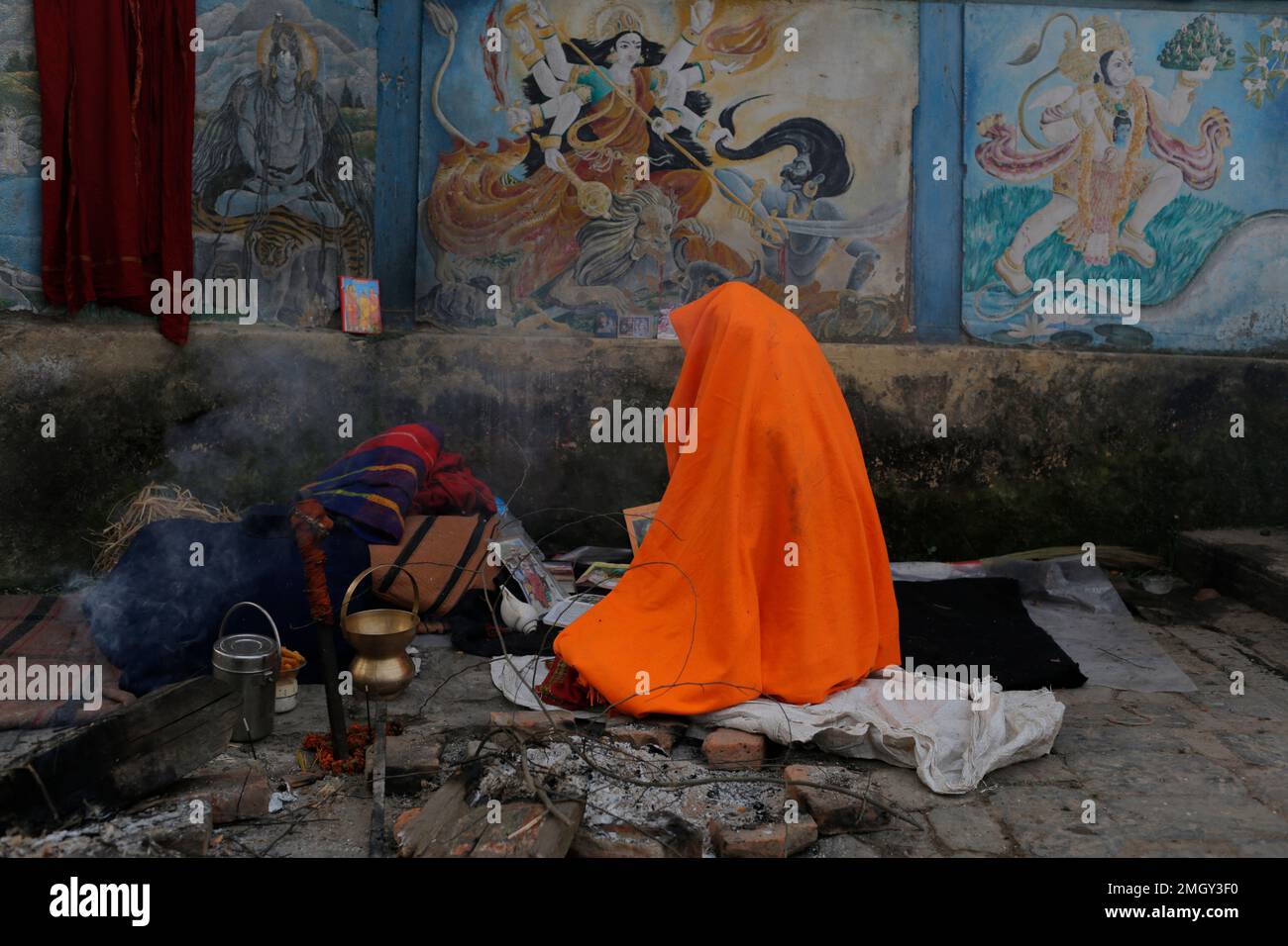 A Hindu holy man performs morning rituals at the courtyard of Pashupati ...