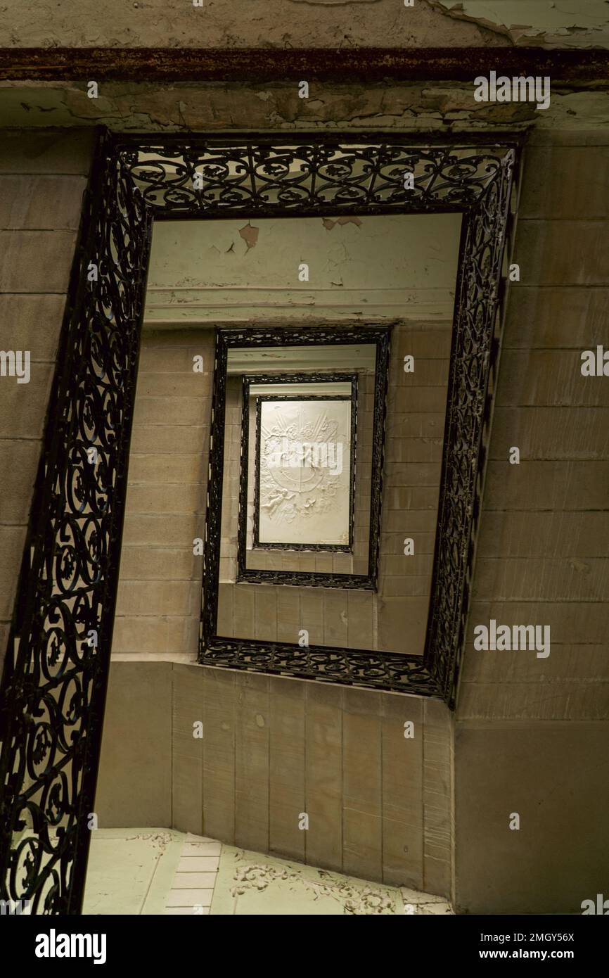 a staircase photographed from below with a railing in a residential ...