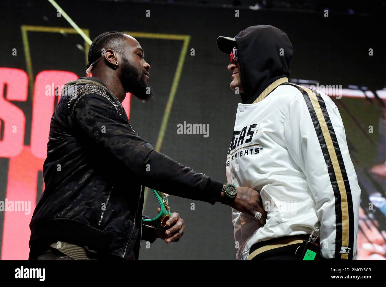 Deontay Wilder, left, shoves Tyson Fury, of England, during a face off ...
