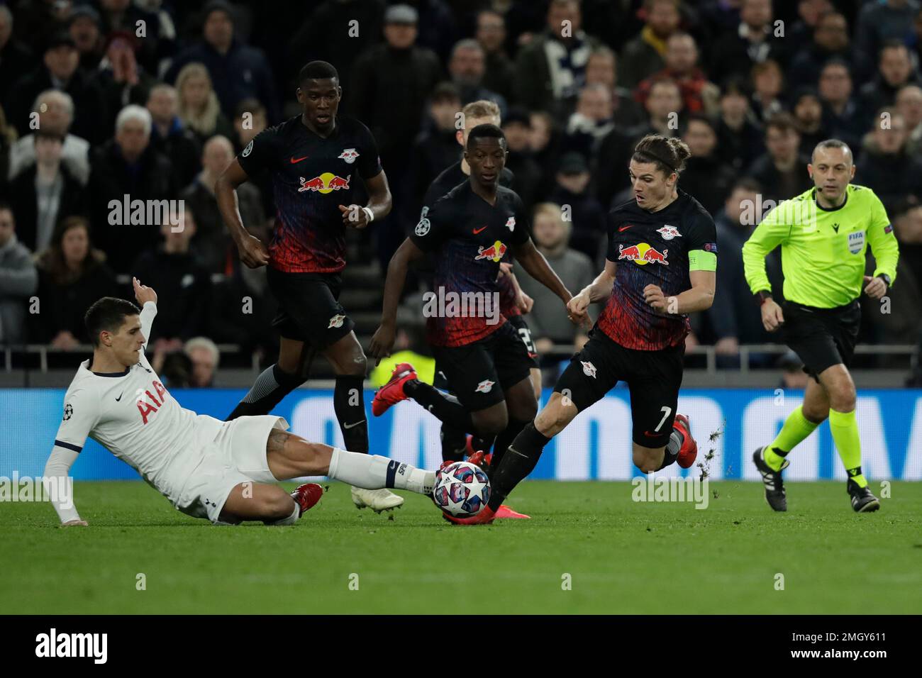 Tottenham's Erik Lamela, left, fights for the ball with Leipzig's ...