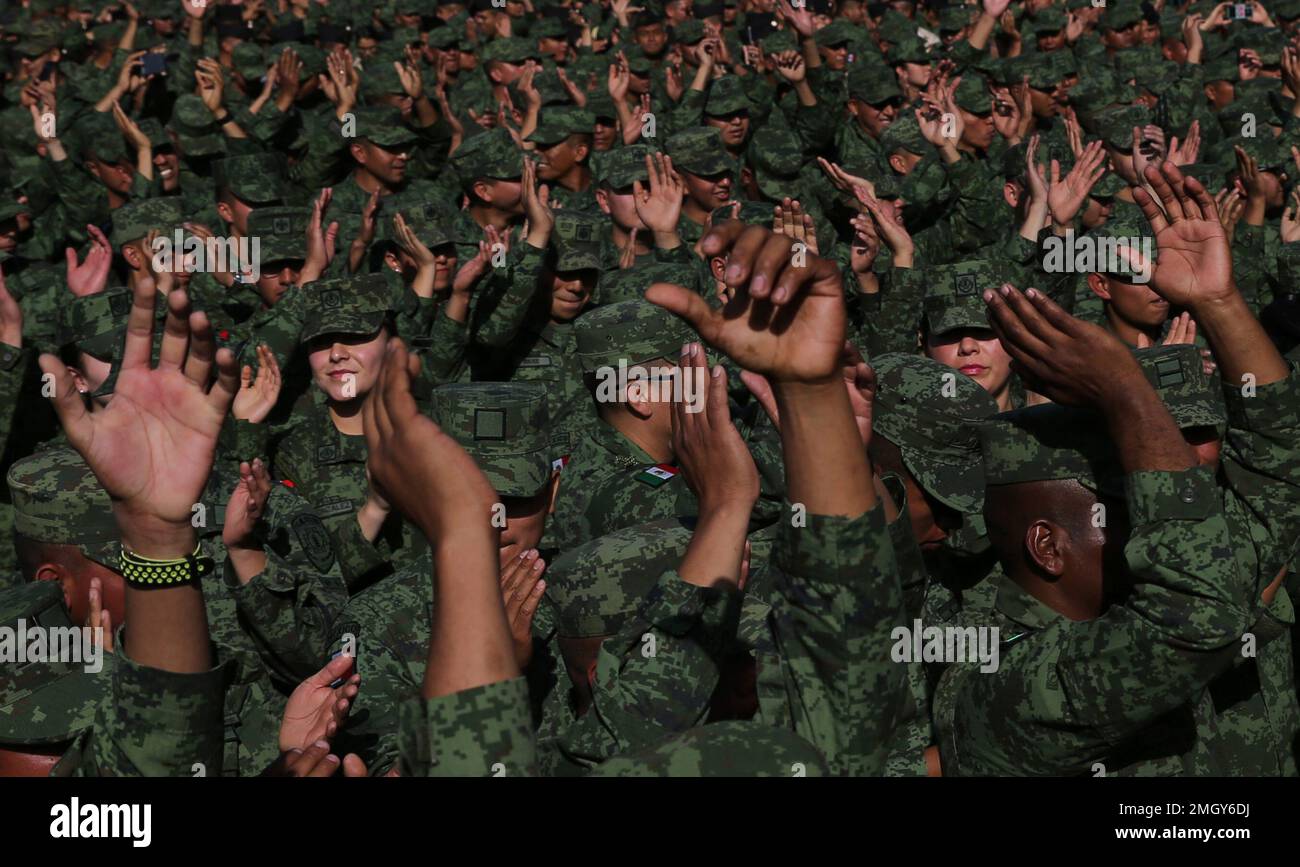 Mexican soldiers cheer during a ceremony to mark Army Day at the Zocalo ...