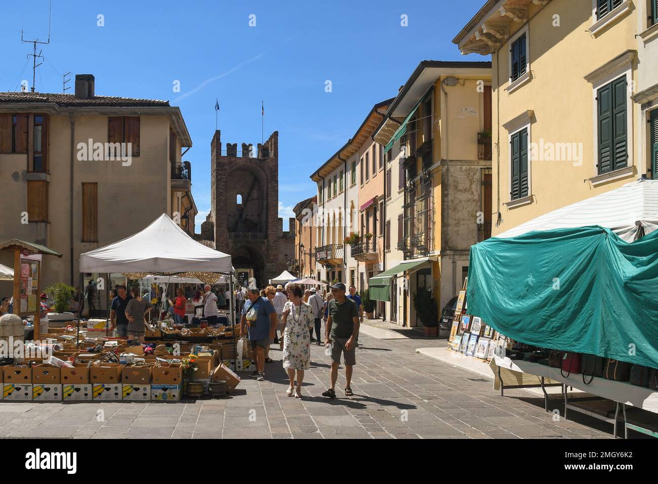 Antiques market in the main street of Soave with Porta Verona city gate ...