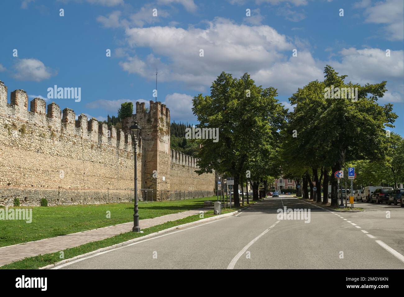 The medieval city walls of the Scaliger Castle overlooking a tree lined ...