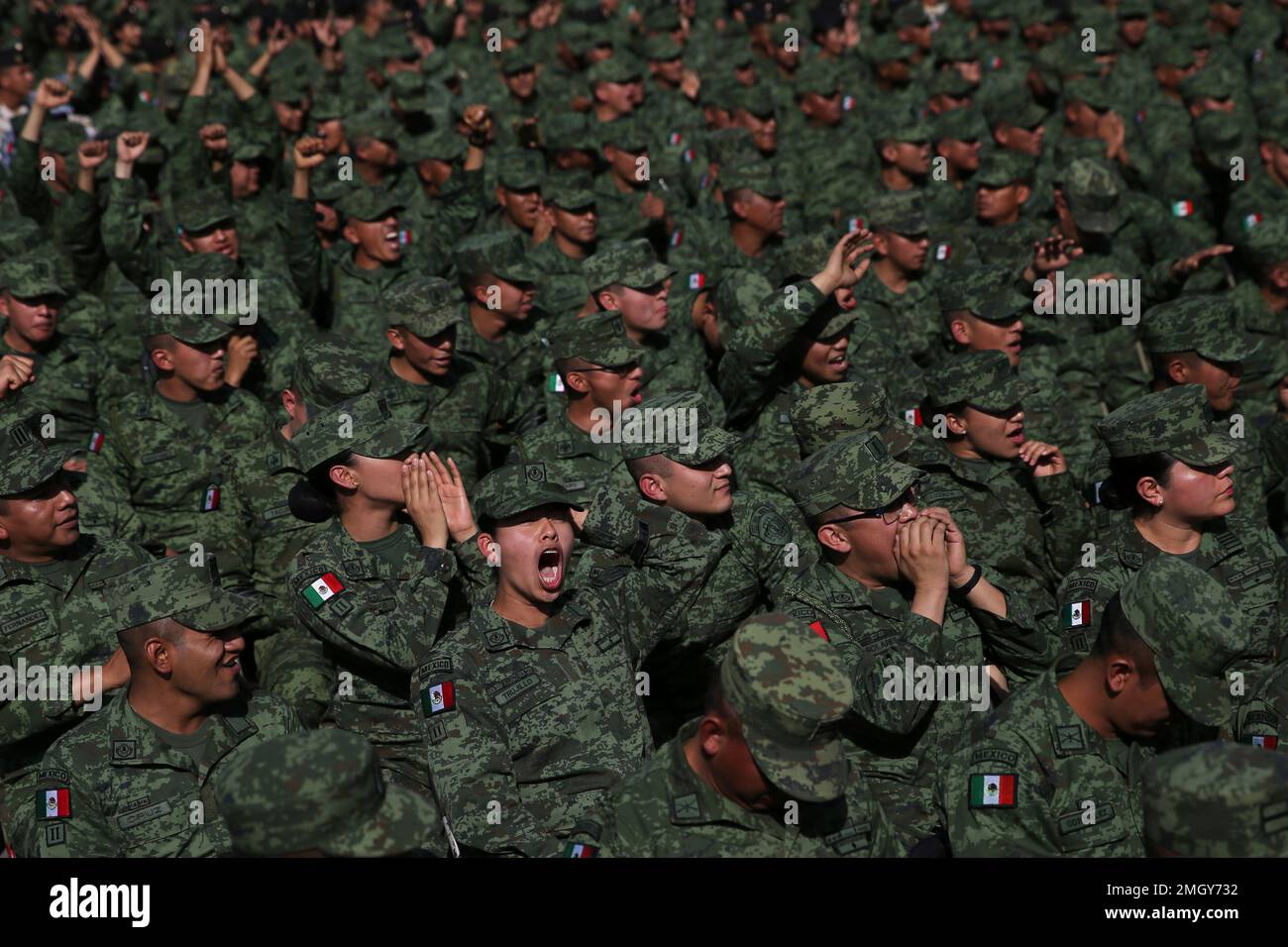 Mexican soldiers cheer during a ceremony to mark Army Day at the Zocalo ...