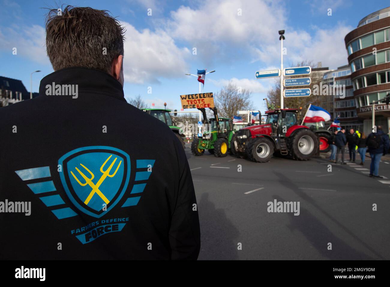 A farmer wearing the Farmers Defense Force jacket stands at an ...