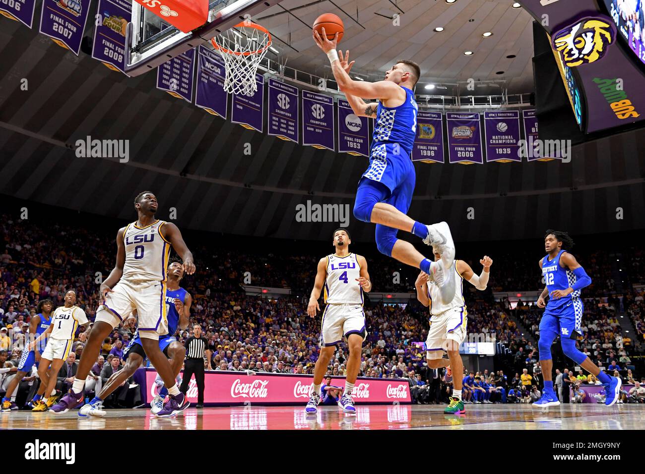 Kentucky forward Nate Sestina (1) shoots as LSU forward Darius Days (0 ...