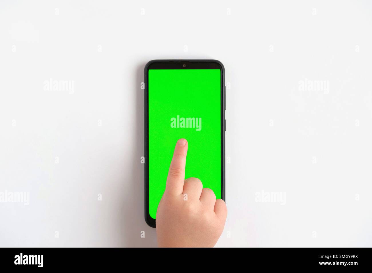 Child hand touching clicking on mobile phone with chromakey screen. Little Baby Finger Taps in ...