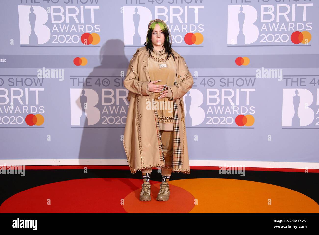Singer Billie Eilish poses for photographers upon arrival at the Brit ...