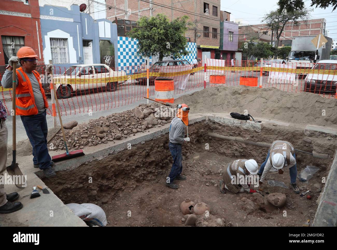 In this Feb. 11, 2020 photo, archaeologists excavate ancient bones and ...