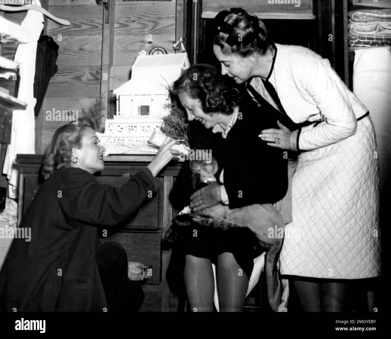 Actor Gertrude Lawrence holds a three-week-old lamb while Constance ...