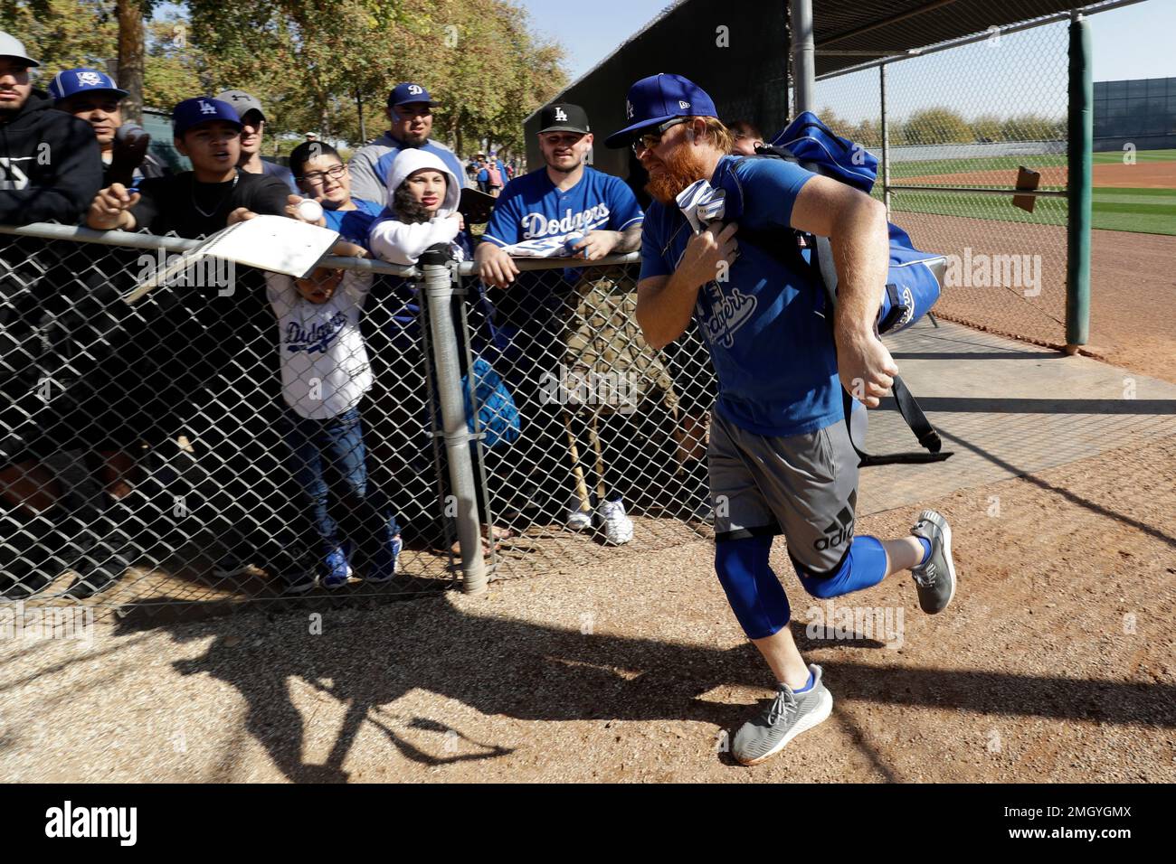 Los Angeles Dodgers third baseman Justin Turner passes fans on his way ...