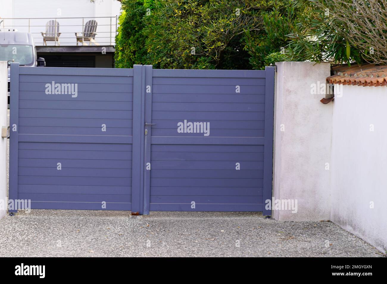 high gray gate metal grey home fence on suburb house Stock Photo - Alamy