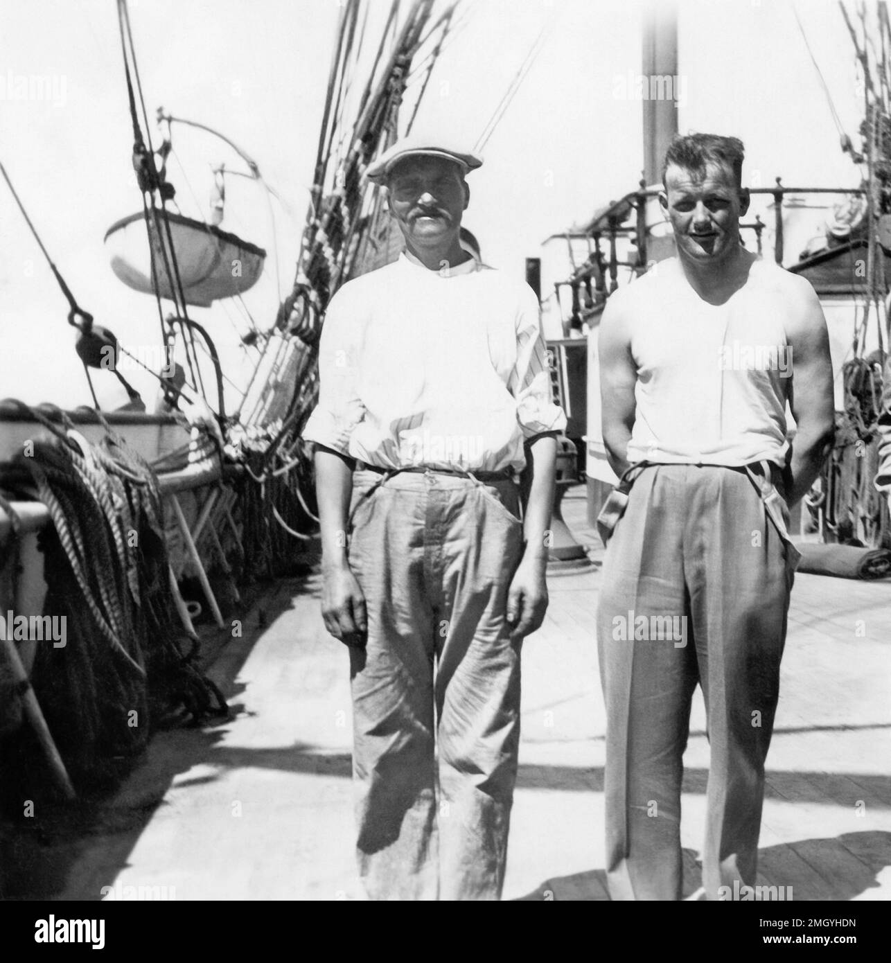 Two sailors standing on the deck of the four-masted steel barque ...