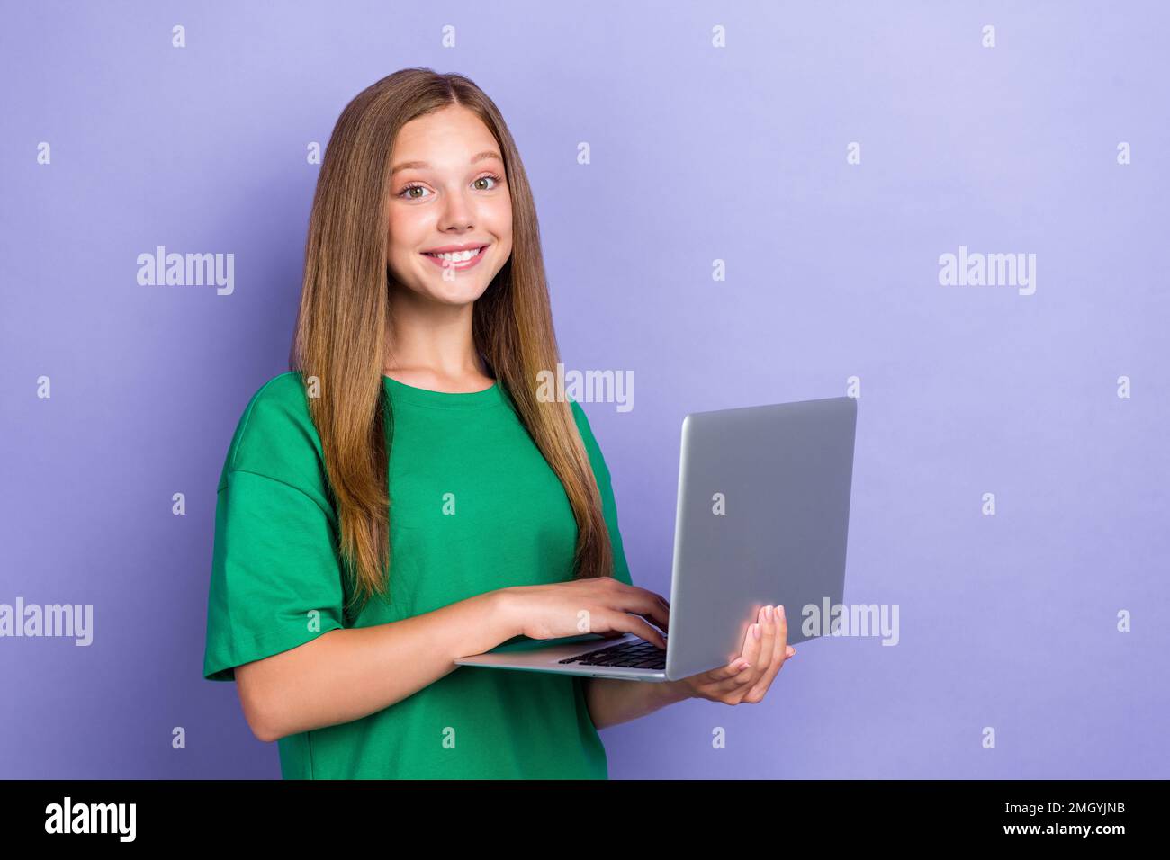 Photo of positive pretty schoolkid pupil hold use netbook do homework ...