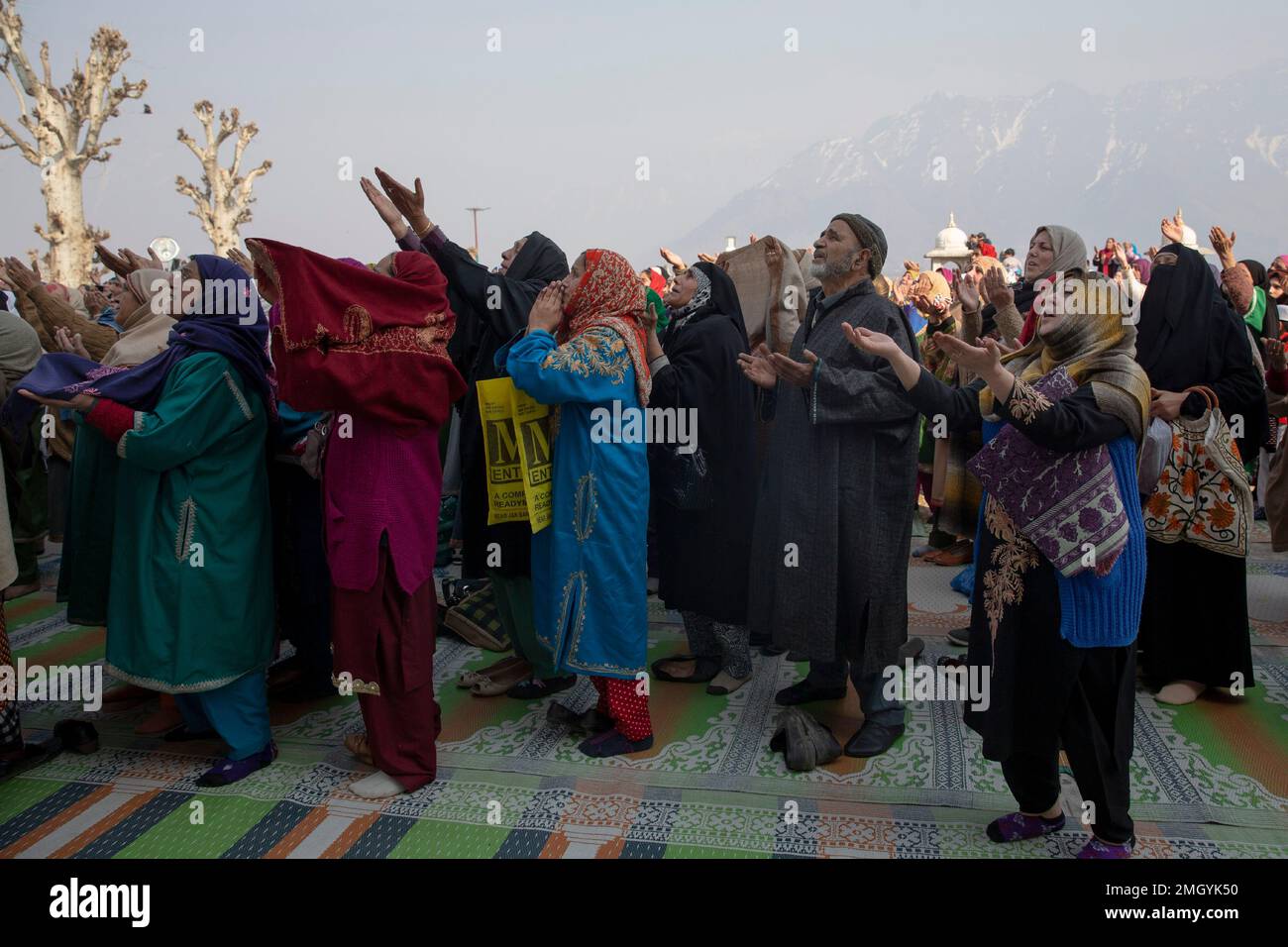 Kashmiri Muslim devotees pray as a head priest displays a relic ...