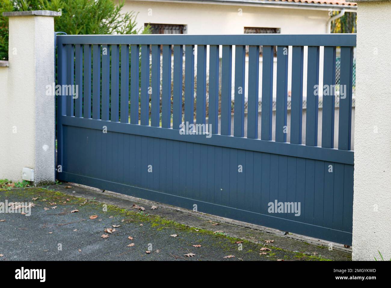 Metal grey driveway entrance slider gates house access garage in suburb ...