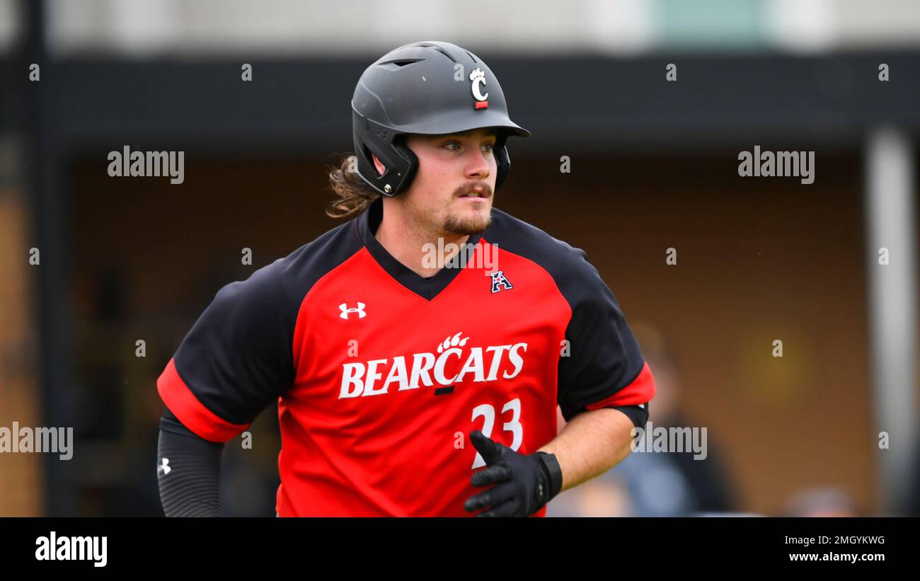 Cincinnati player Mitch Holding advances to first base during an NCAA ...