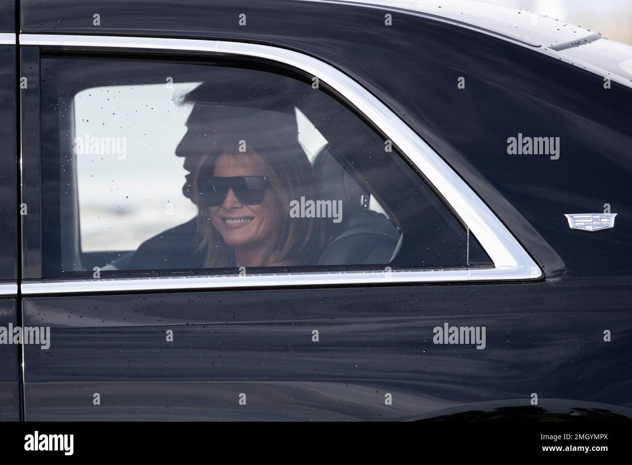 First lady Melania Trump smiles as they head to their planes at Daytona ...