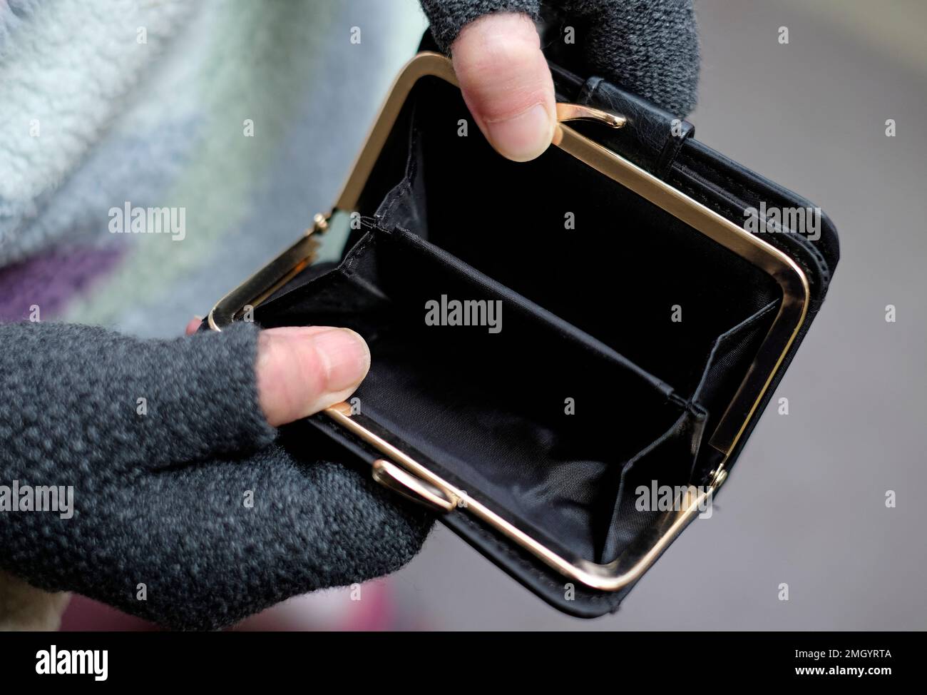 senior person holding open empty purse Stock Photo - Alamy