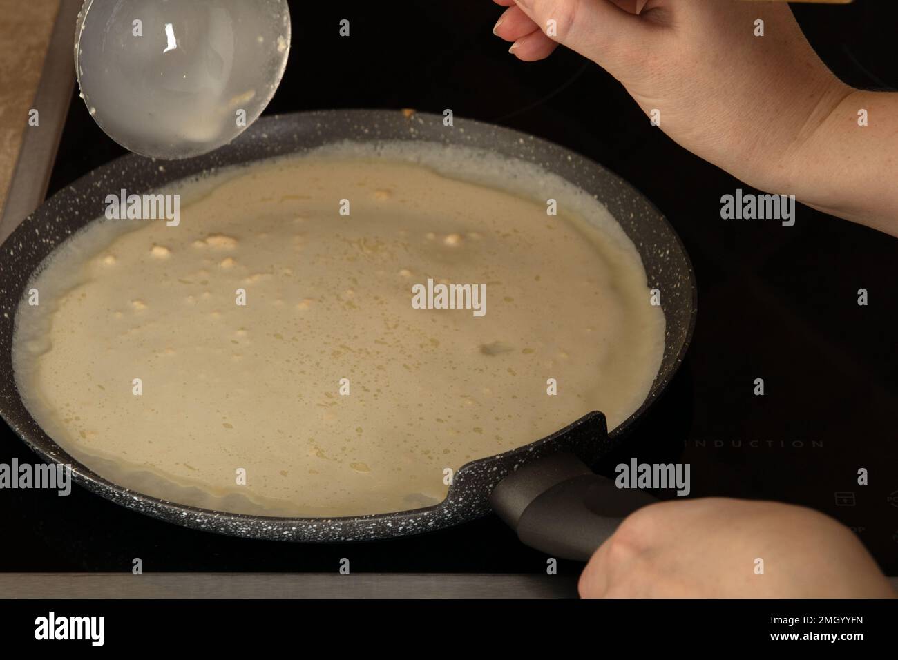 photo liquid dough frying in a pan on a home stove Stock Photo - Alamy