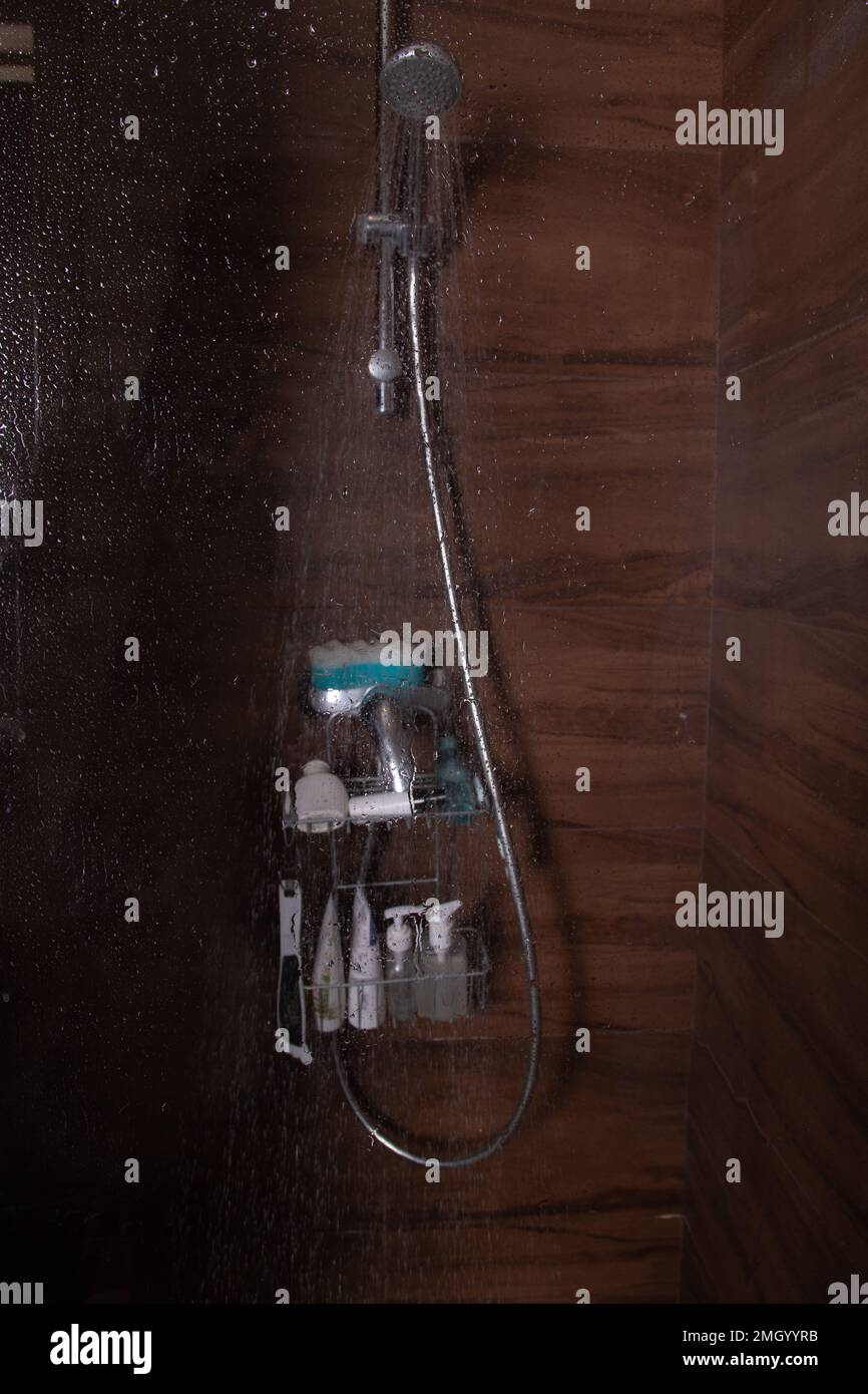 photo in the shower cubicle pouring water from the shower, view through ...